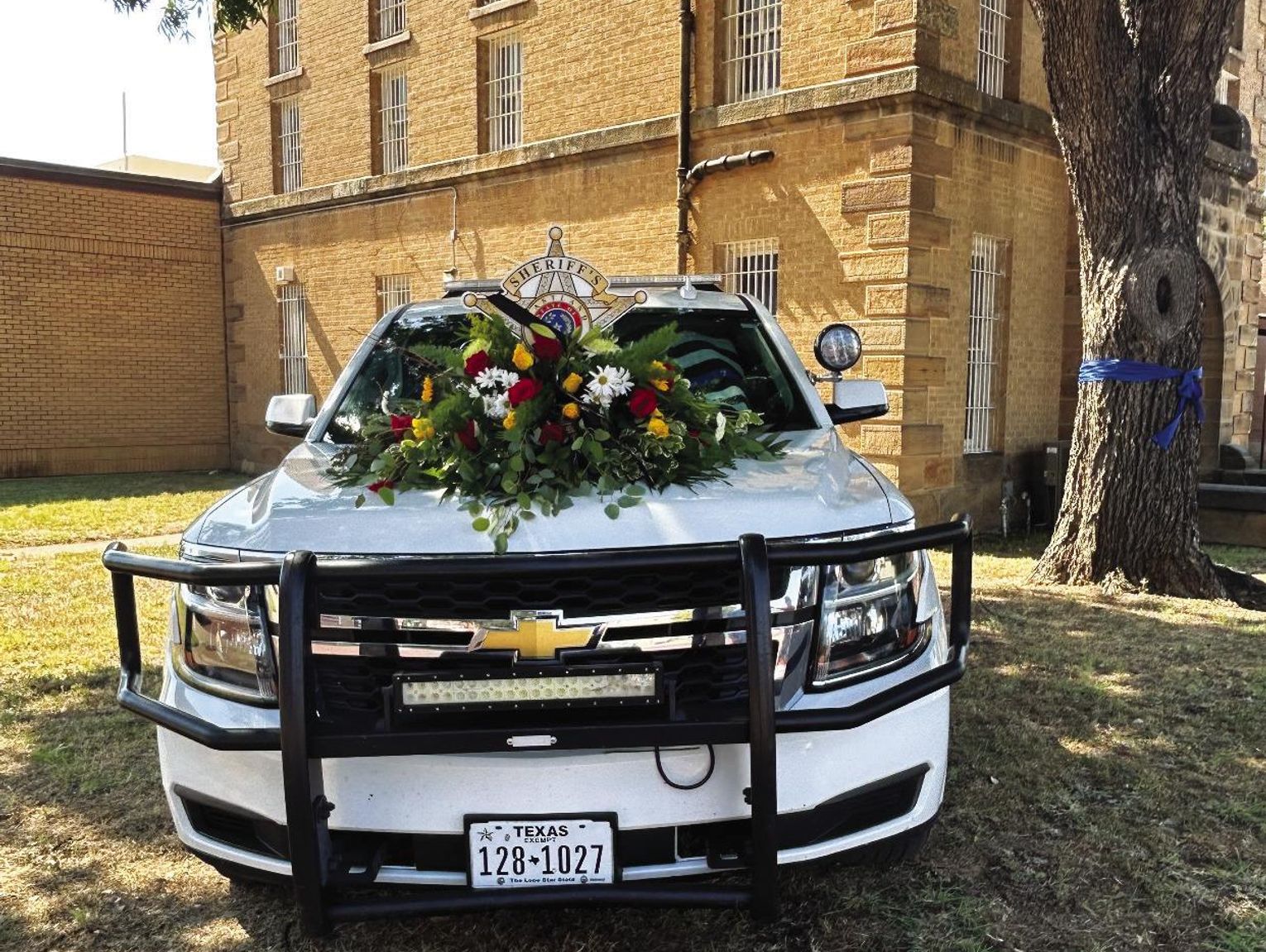 Patrol Vehicle with Flowers set up at Sheriff’s Office