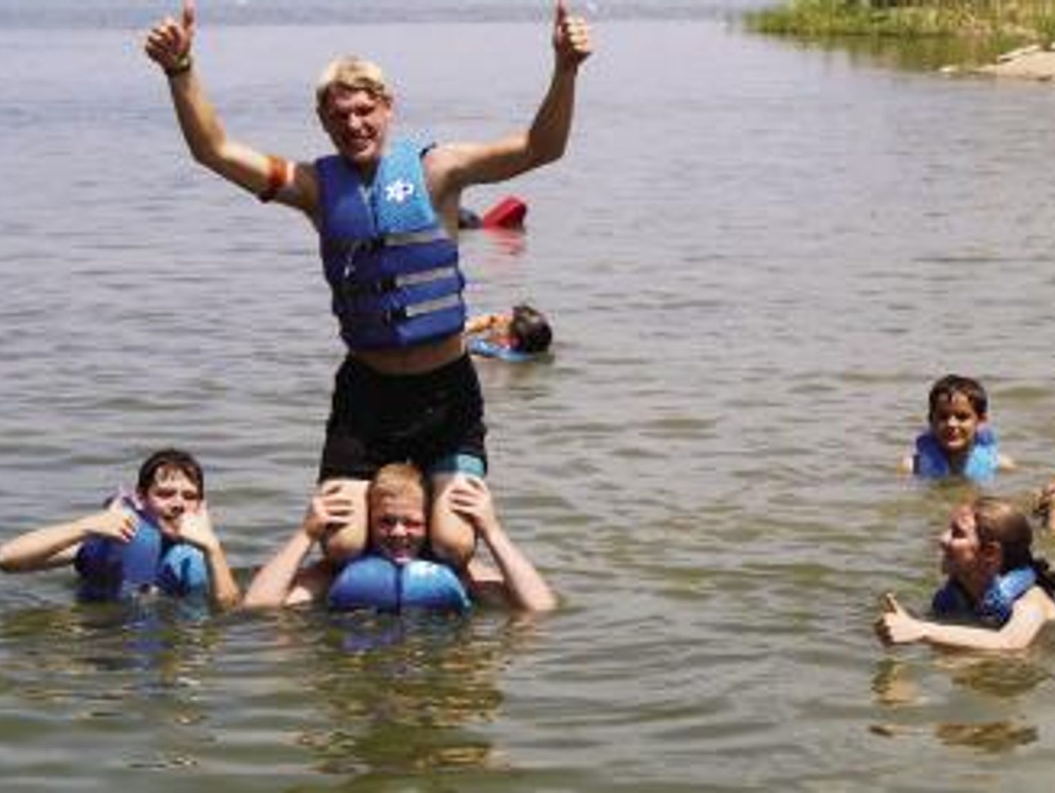 Youth enjoy a game in Lake Leon at the Solid Rock Camp Teen Week